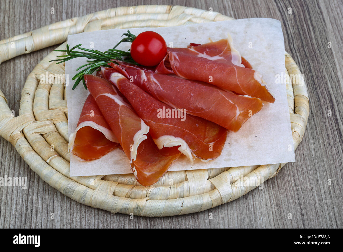 Spanish traditional snack - Jamon with tomato and rosemary Stock Photo ...