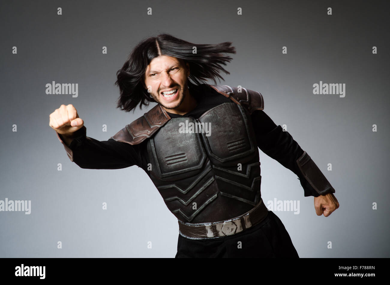 Angry warrior against dark background Stock Photo - Alamy