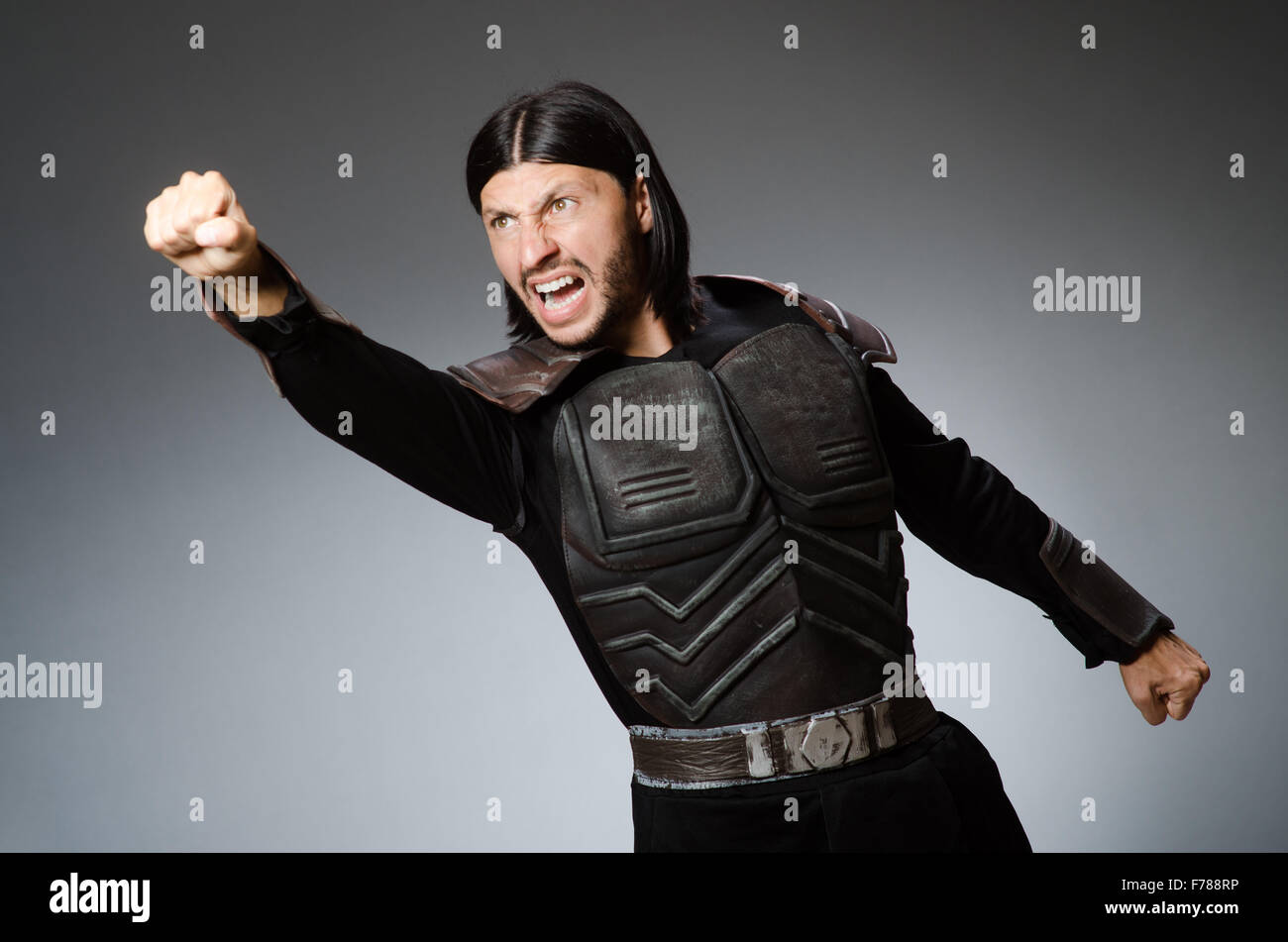 Angry warrior against dark background Stock Photo - Alamy