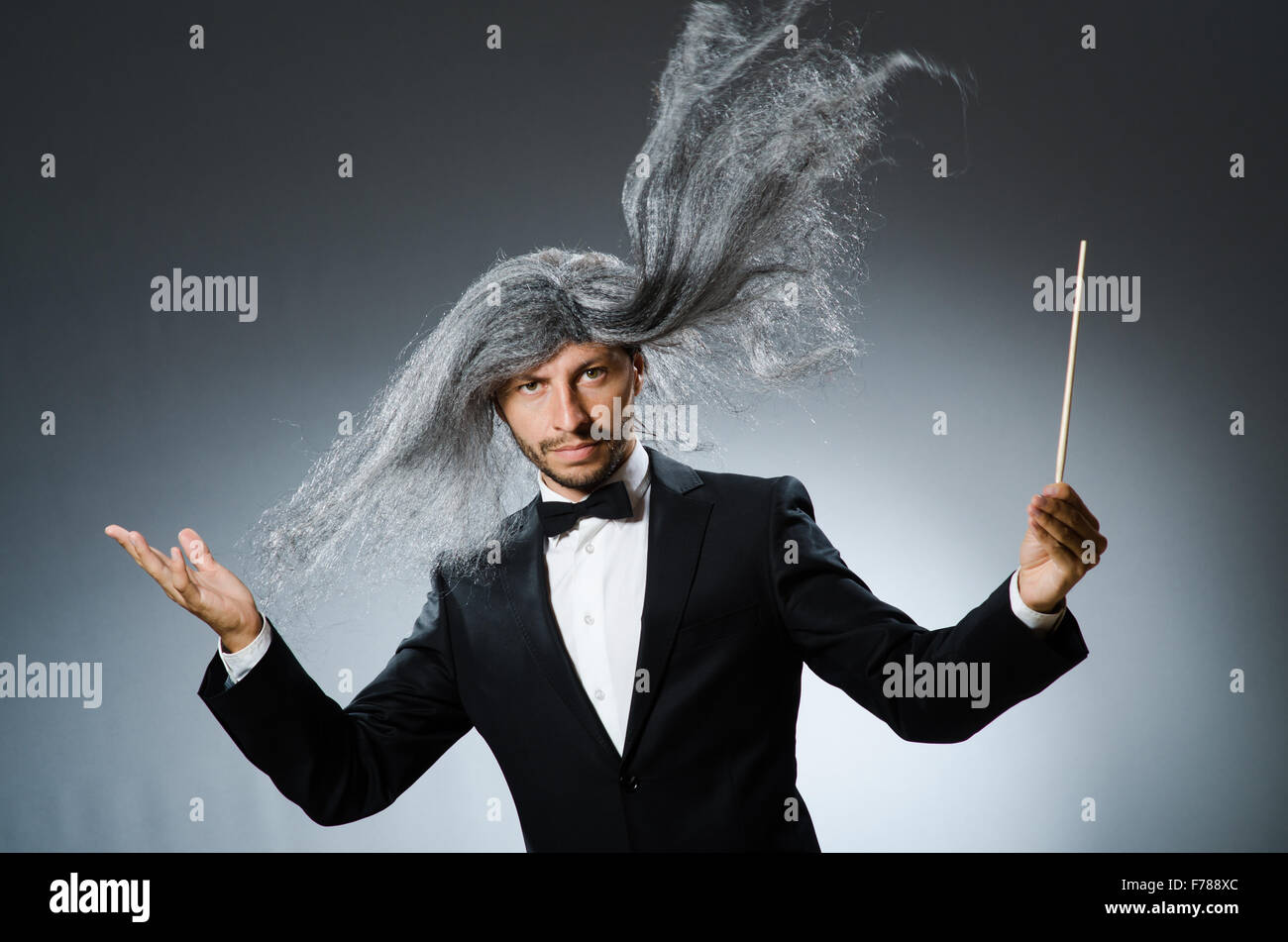 Funny conductor with long grey hair Stock Photo - Alamy