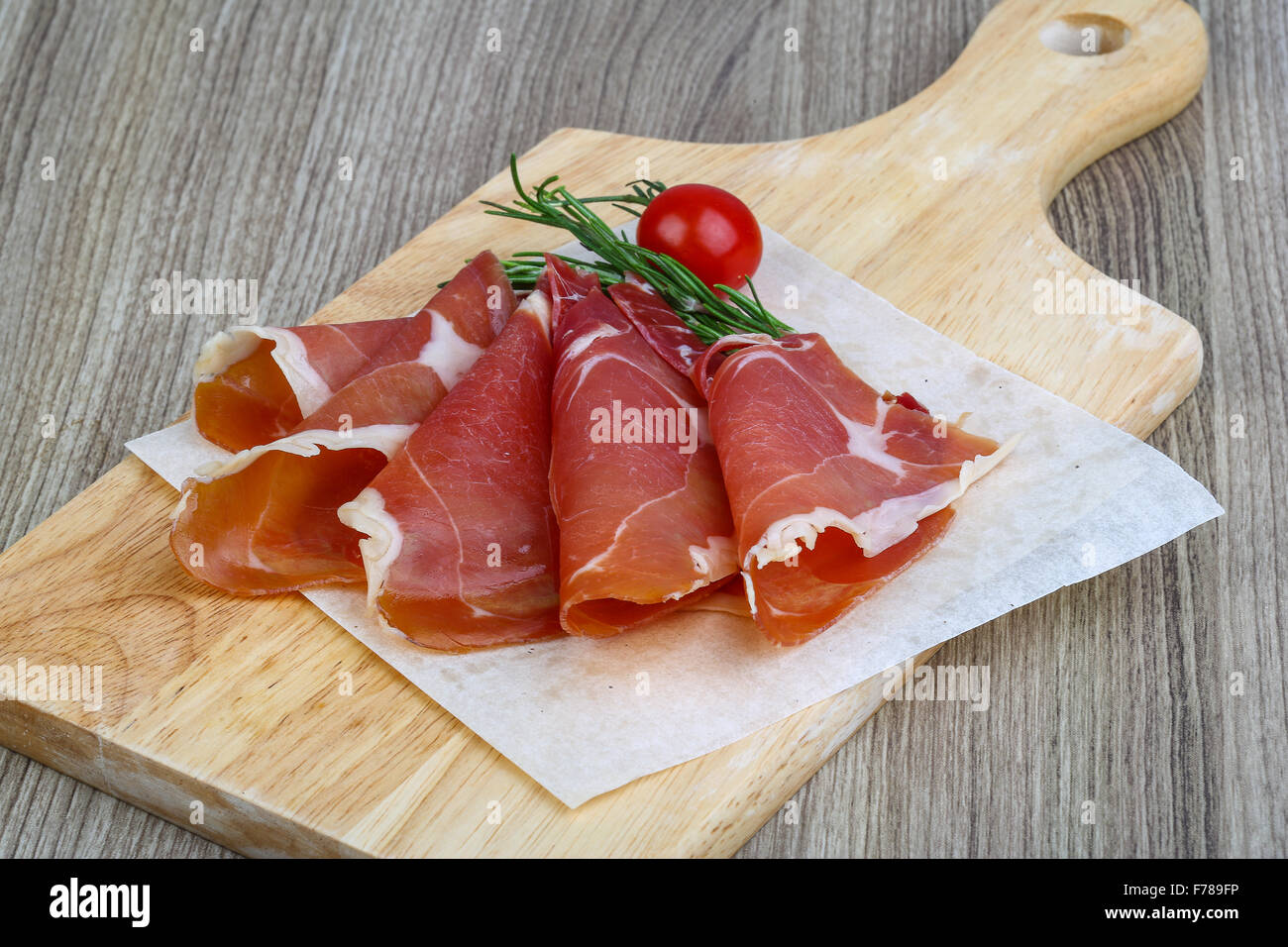 Spanish traditional snack - Jamon with tomato and rosemary Stock Photo ...