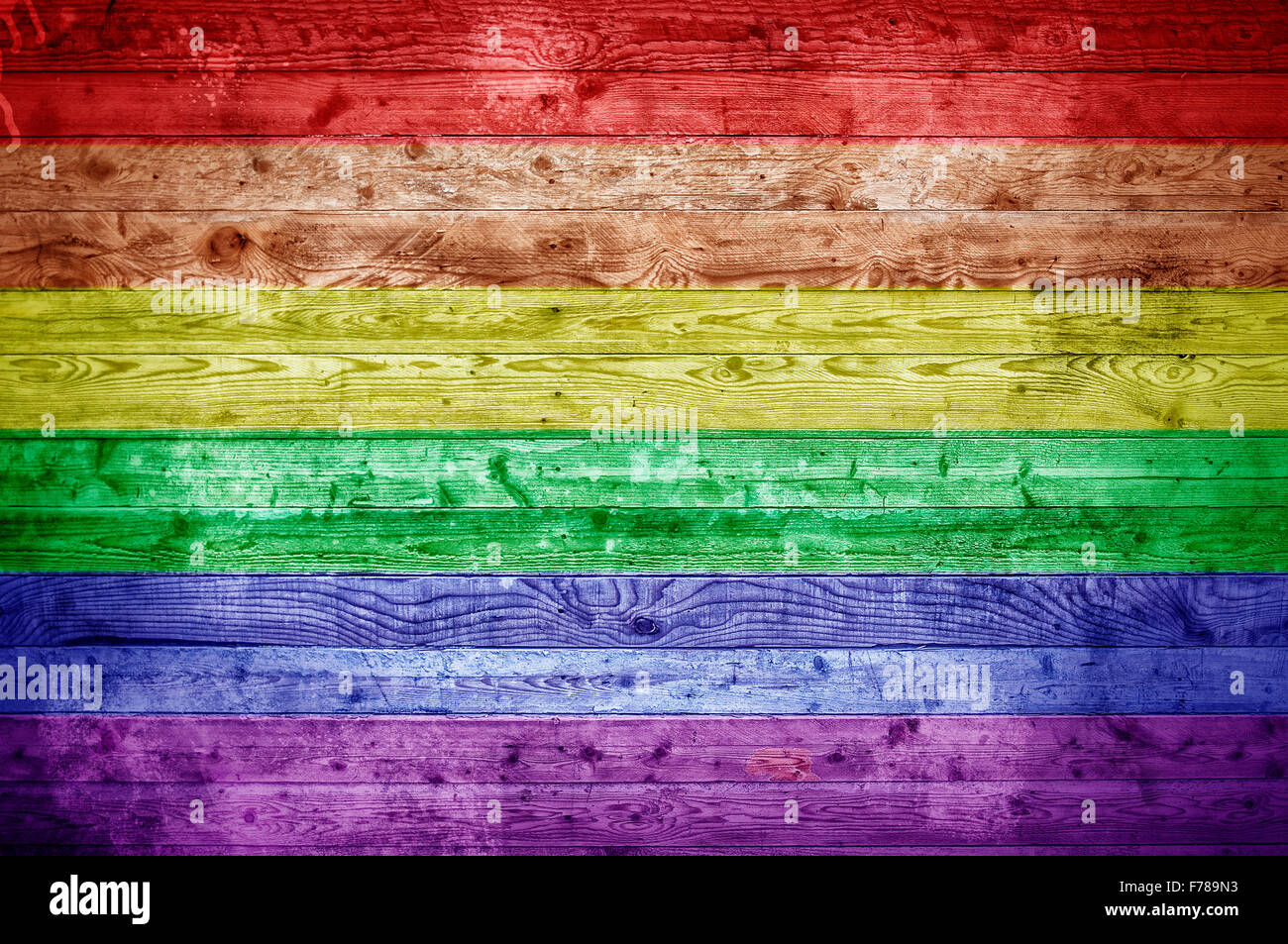 A vignetted background image of the flag of Gay Pride onto wooden ...