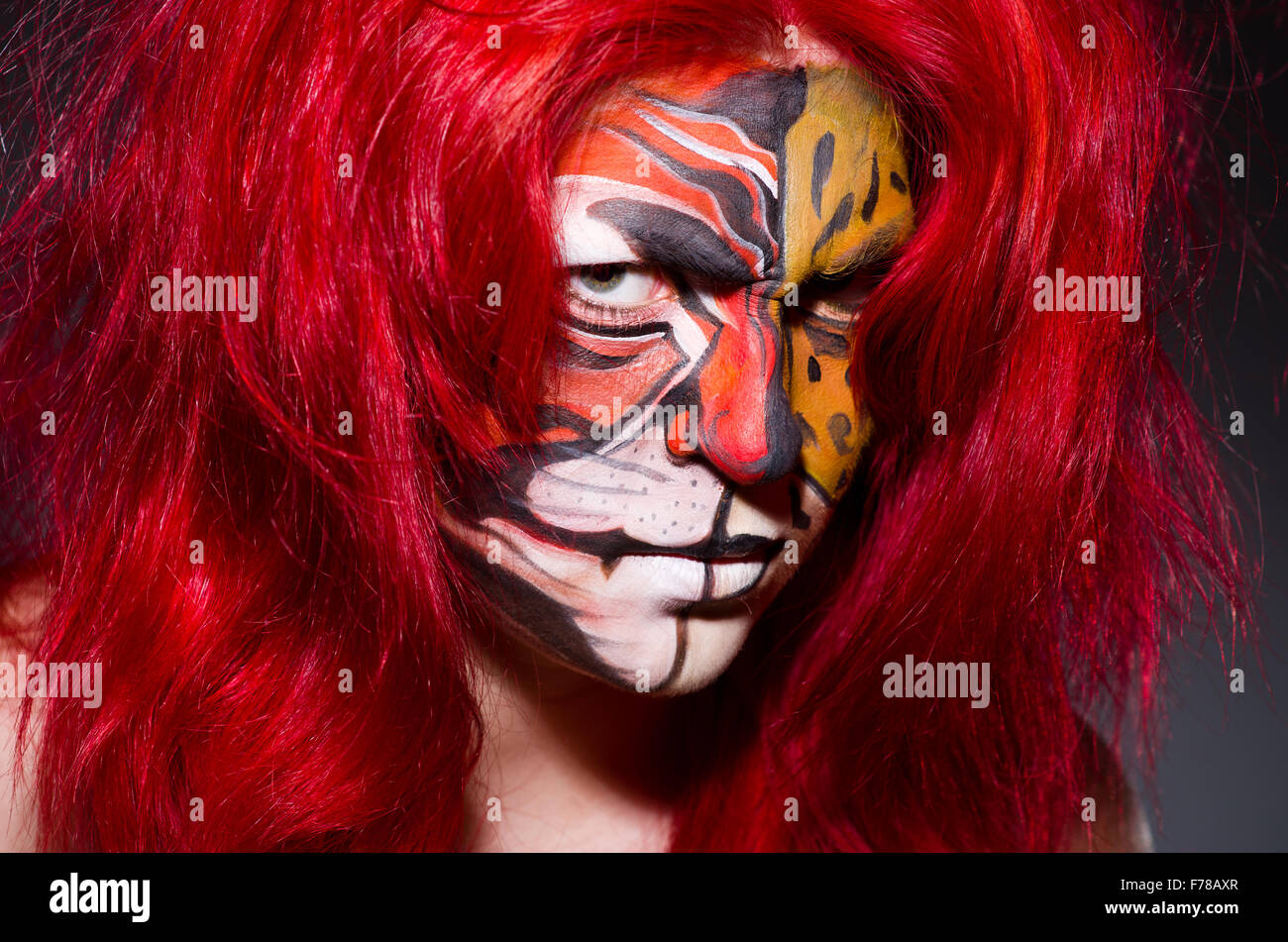 Woman with tiger face in halloween concept Stock Photo - Alamy