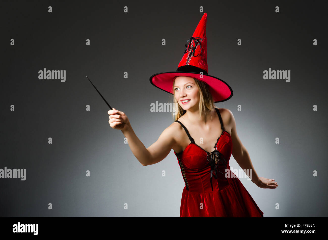 Woman magician doing her tricks with wand Stock Photo - Alamy