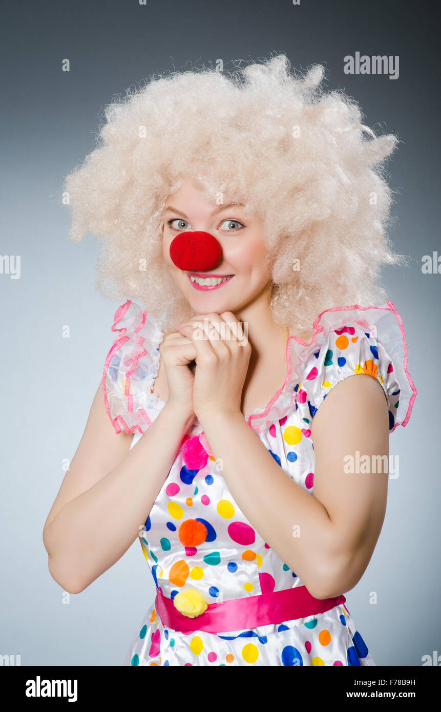 Clown with white wig against grey background Stock Photo - Alamy