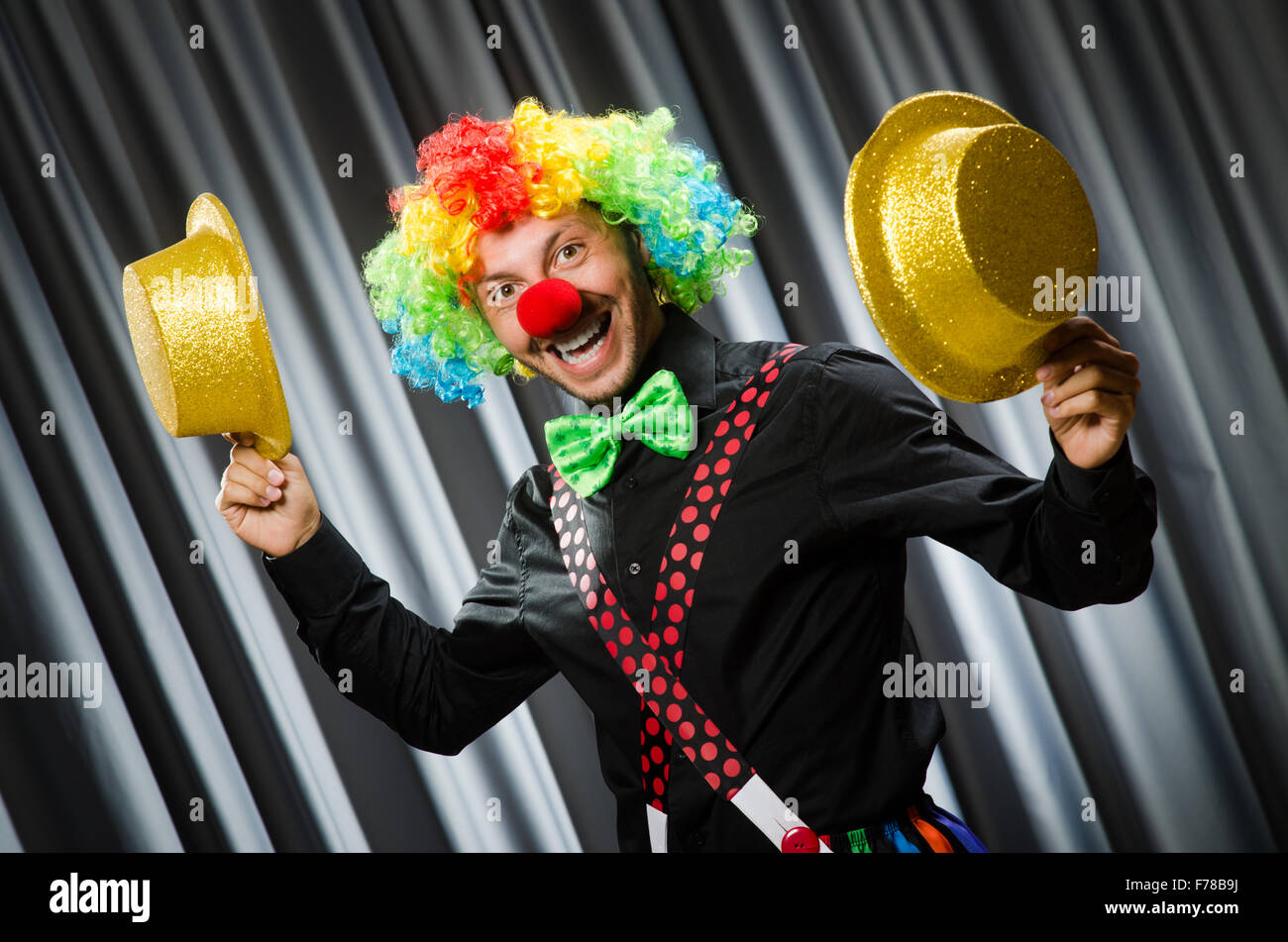 Funny clown in humorous concept against curtain Stock Photo - Alamy