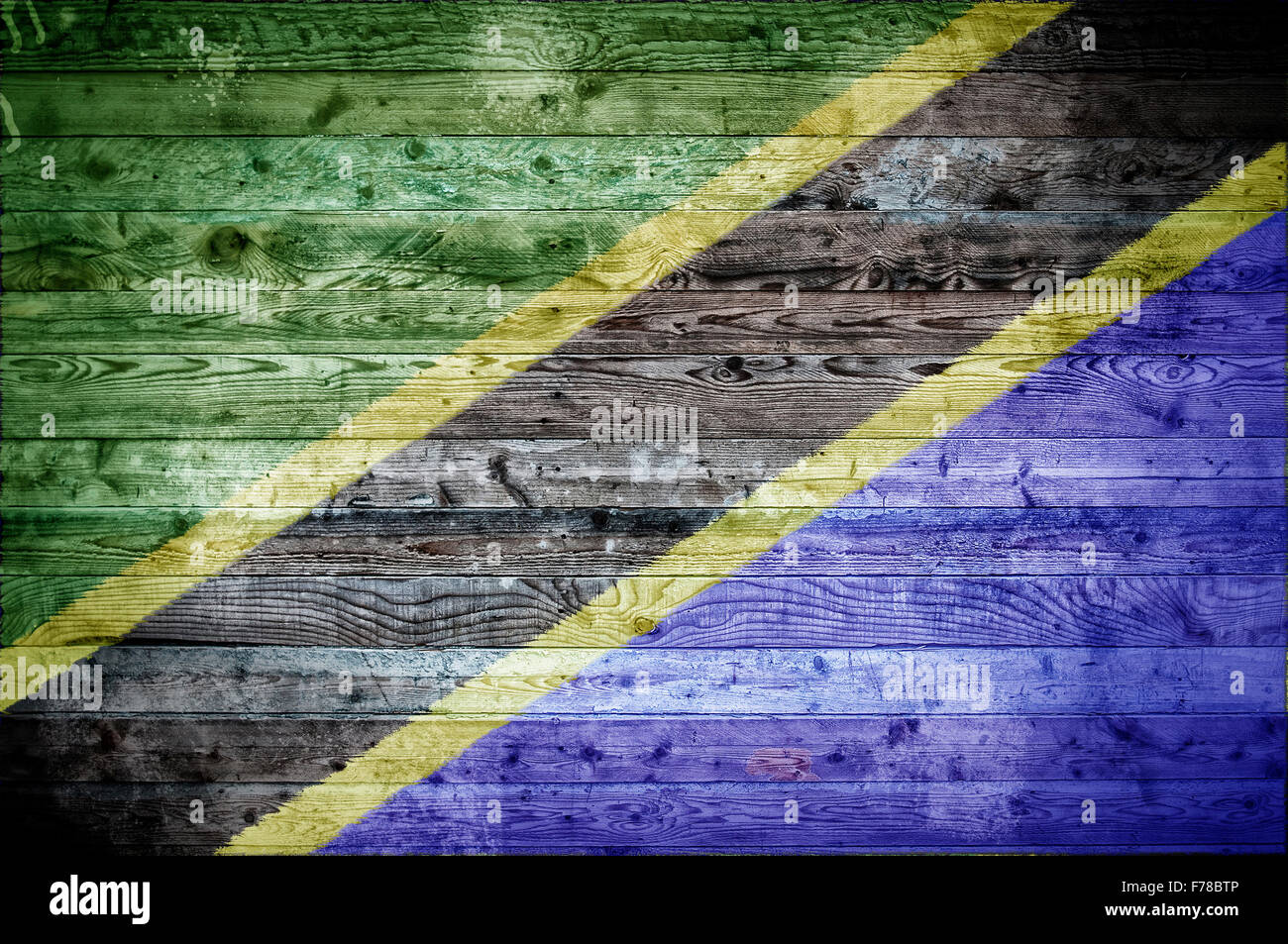 A vignetted background image of the flag of Tanzania onto wooden boards ...