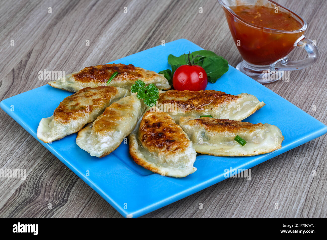 Japanese cousine - Gyoza dumplings served green onion and cherry tomato ...