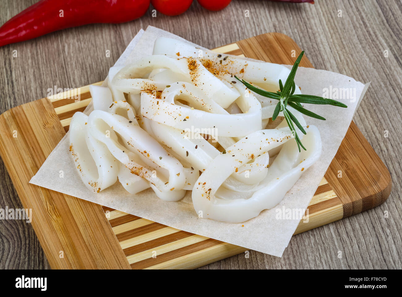 Raw squid rings with herbs - ready for cooking Stock Photo - Alamy