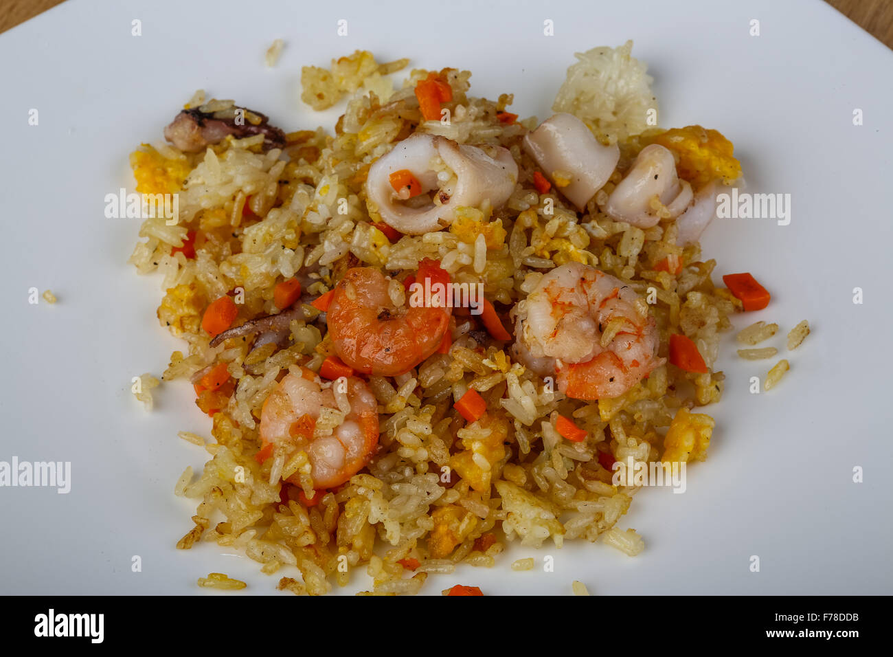 Asian traditional Fried rice with seafood on the wood background Stock ...