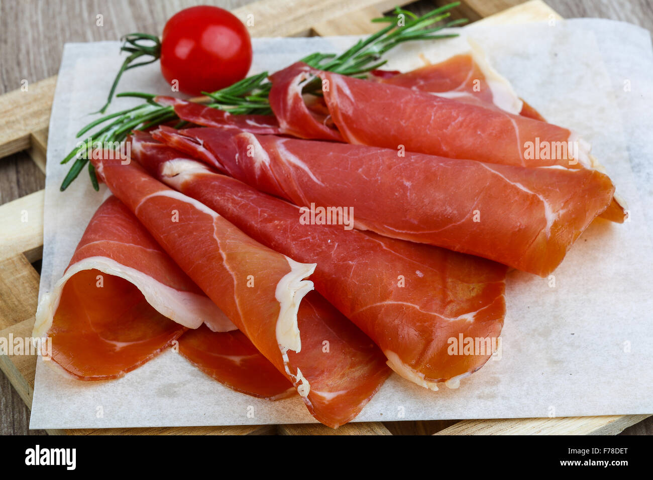 Spanish traditional snack - Jamon with tomato and rosemary Stock Photo ...