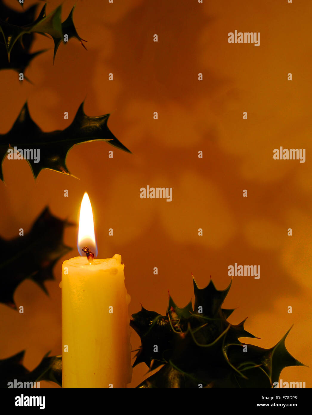 candle and holly Stock Photo - Alamy