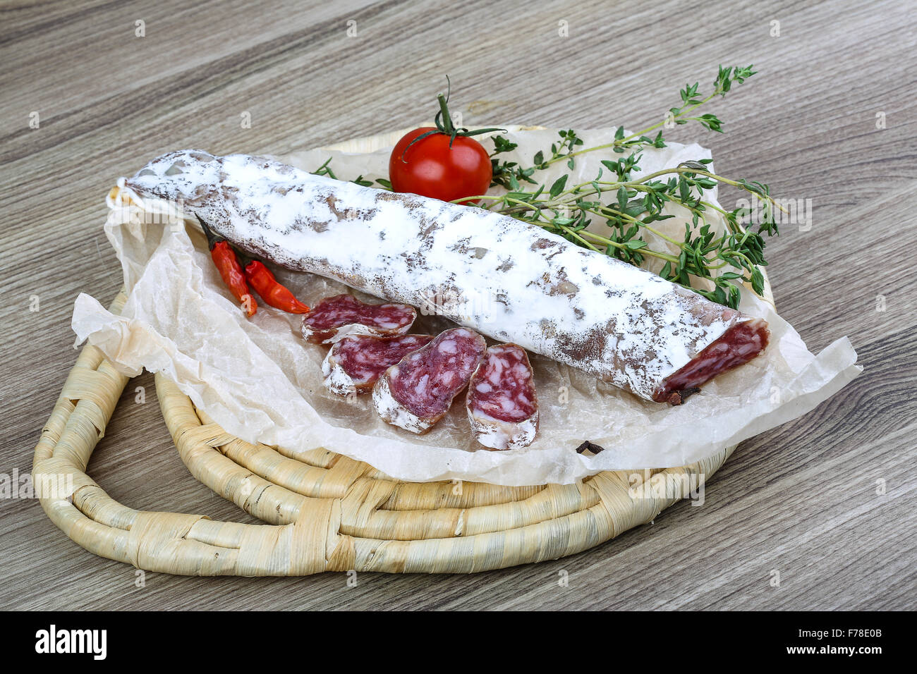 Traditional Spanish sausages- fuet with thyme leaves on the wood ...