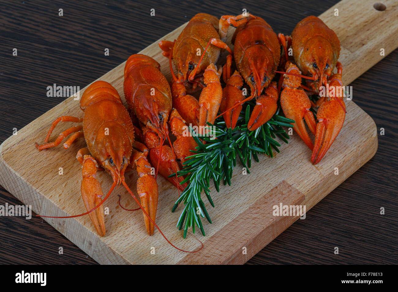 Boiled Crayfish with rosemary on the wood background Stock Photo - Alamy