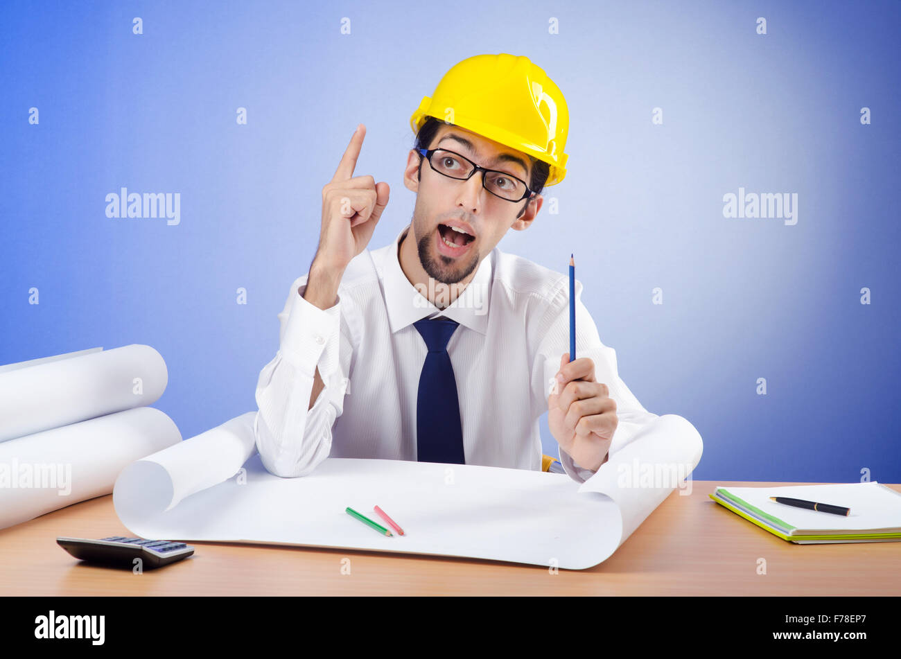 Young engineer looking at drawings Stock Photo - Alamy