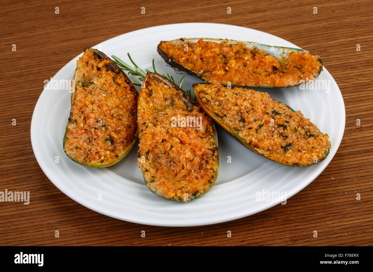 Baked mussels with bread and spices served rosemary Stock Photo - Alamy
