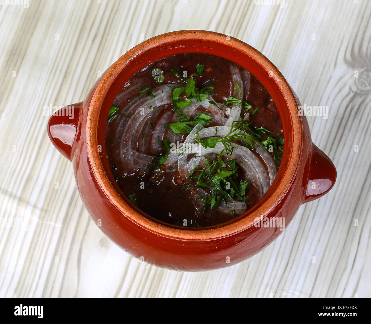 Georgian cuisine - Lobio with onion rings and fresh herbs Stock Photo ...