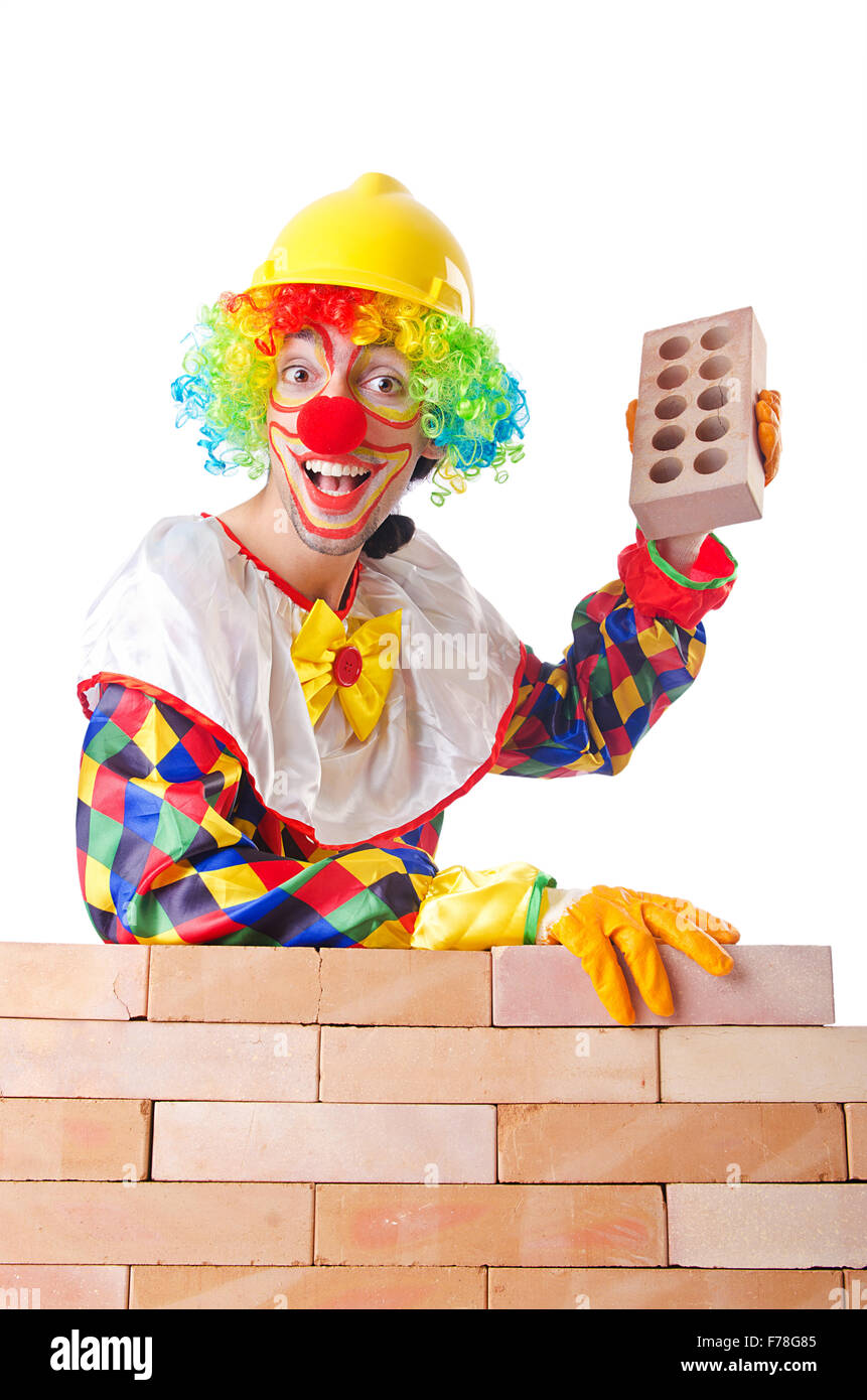 Bad construction concept with clown laying bricks Stock Photo - Alamy