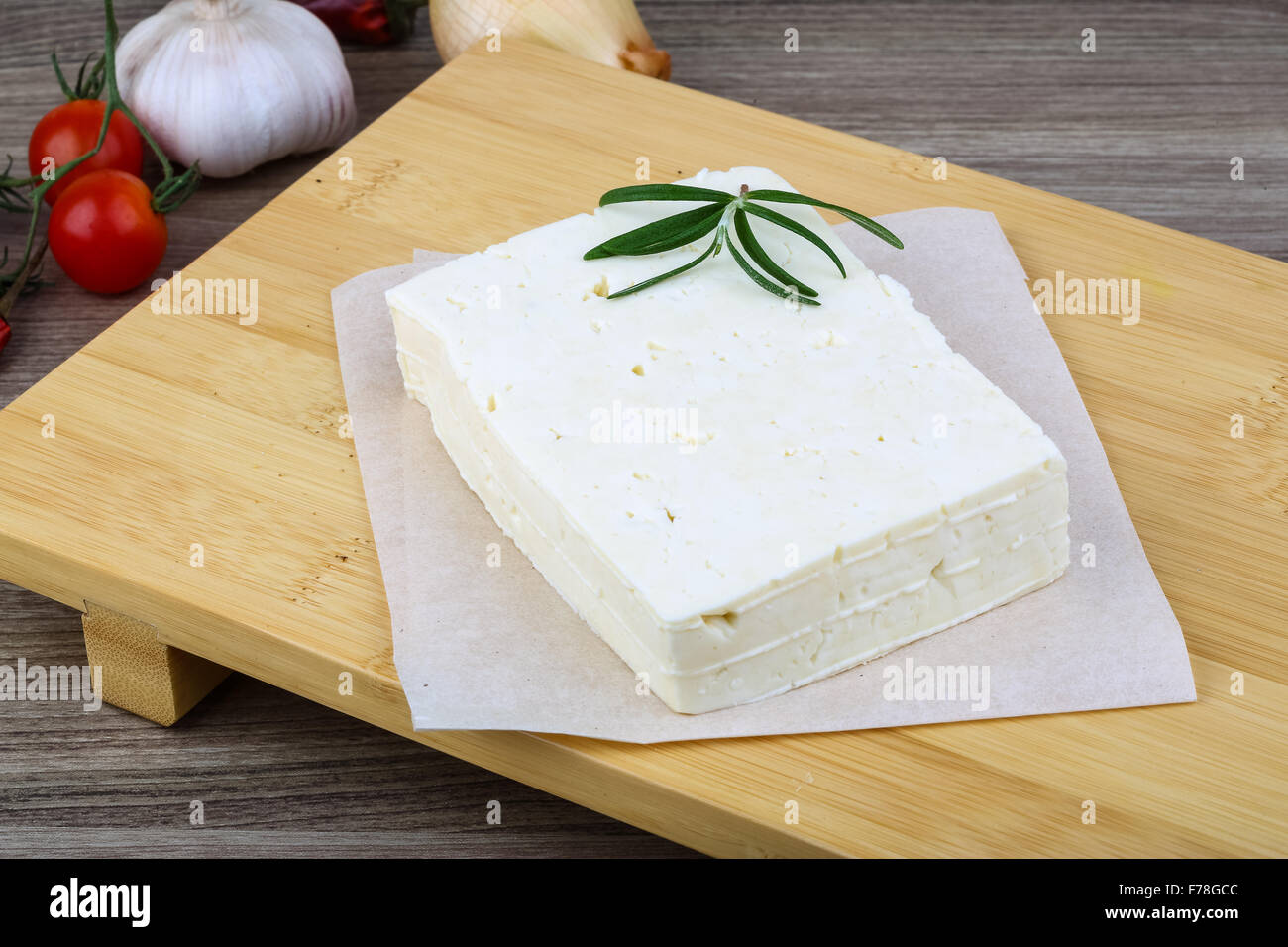 White bulgarian cheese brinza with rosemary on the wood background ...