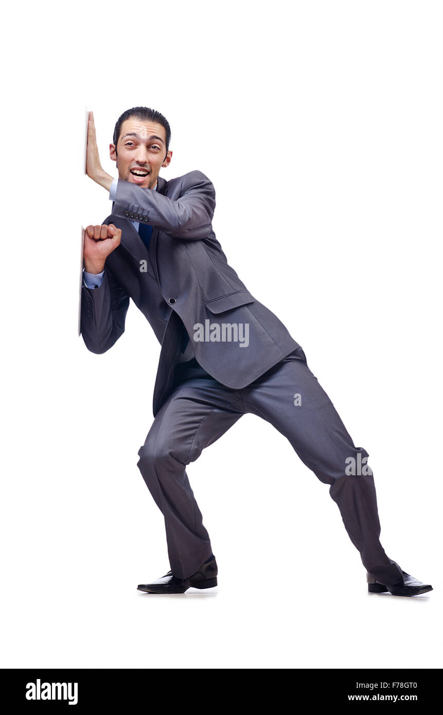 Young businessman pushing invisible obstacles Stock Photo - Alamy