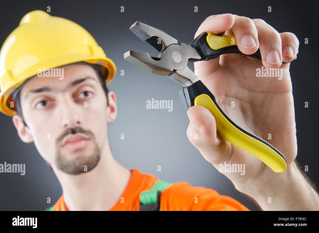 Man with tongs in studio Stock Photo - Alamy