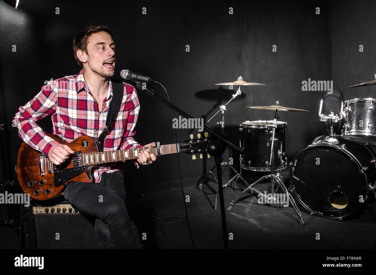 Man with guitar during concert Stock Photo - Alamy