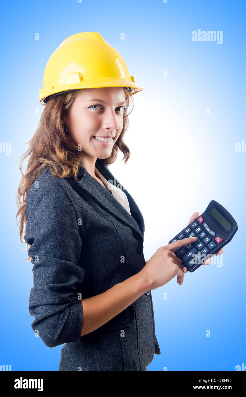 Female builder with calculator on white Stock Photo - Alamy