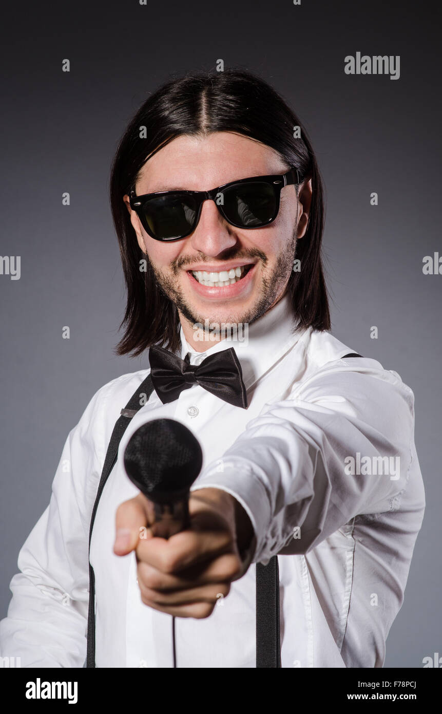Funny singer with microphone at the concert Stock Photo - Alamy