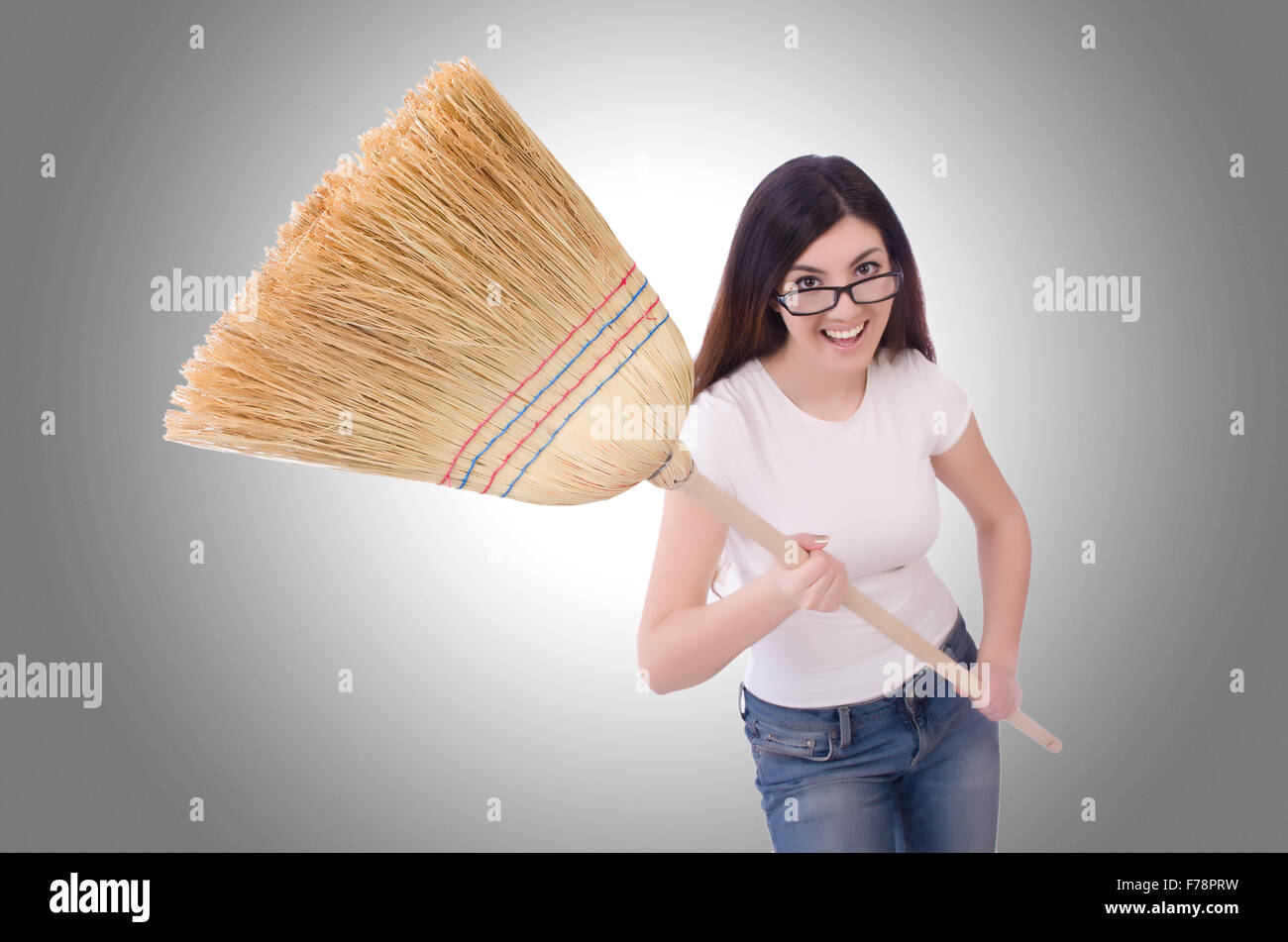 Young woman with broom on white Stock Photo - Alamy