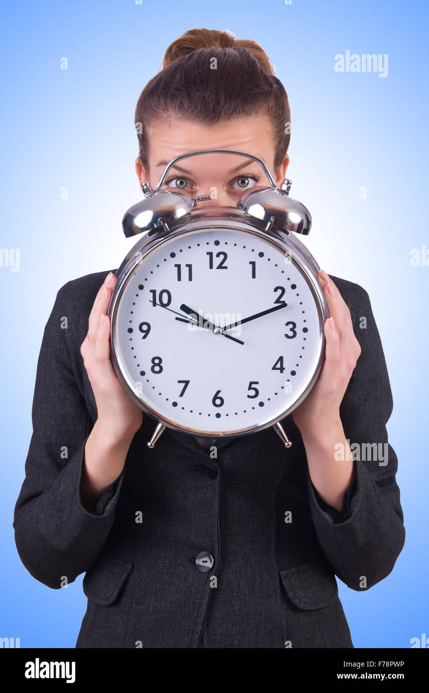 Woman with giant clock on white Stock Photo - Alamy