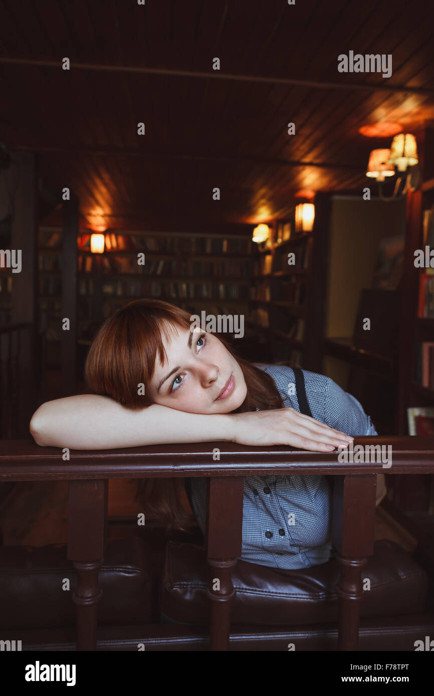 Beautiful female student in a university library Stock Photo - Alamy