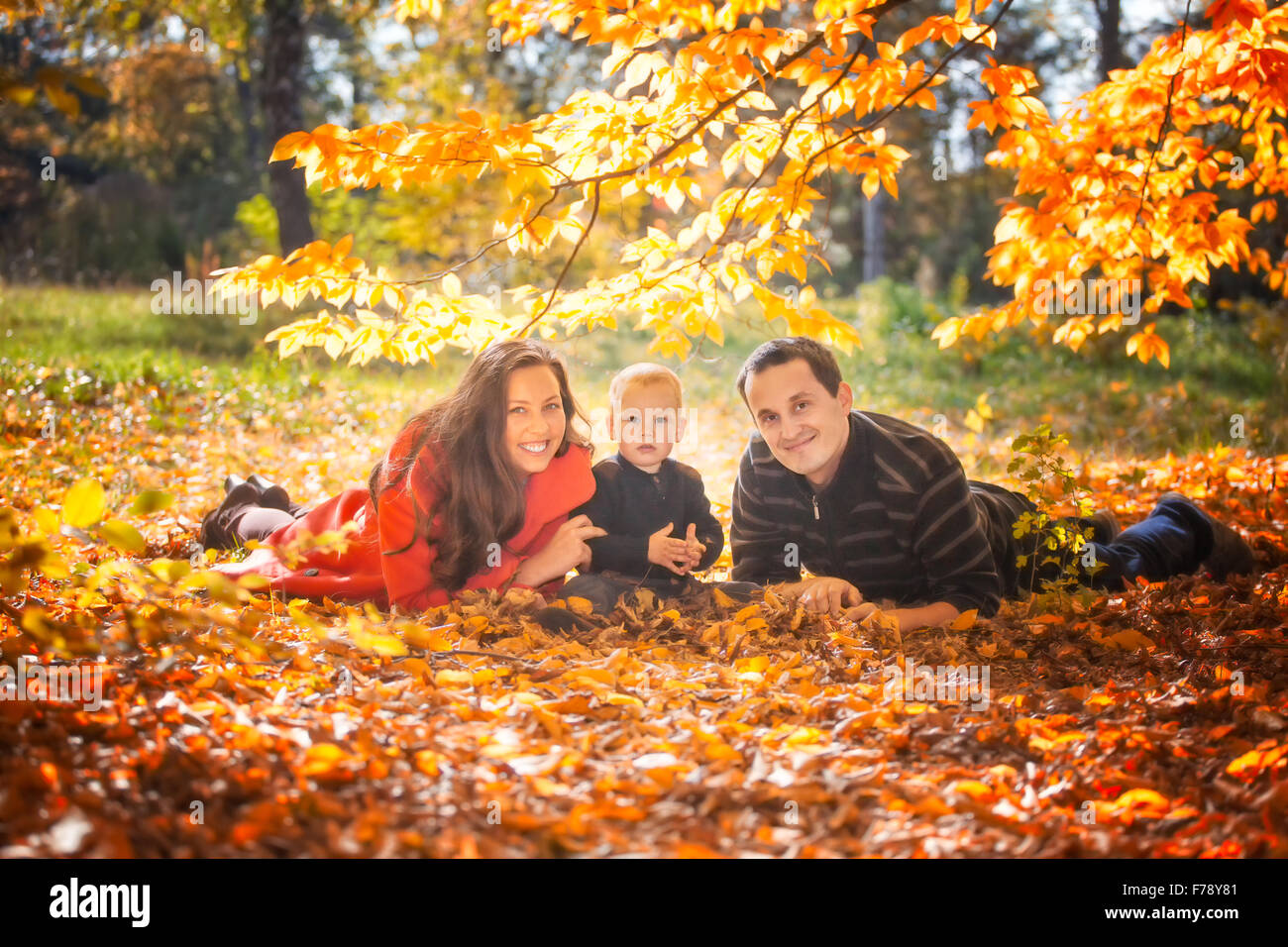 Portrait of family enjoying a day in the woods during fall Stock Photo ...