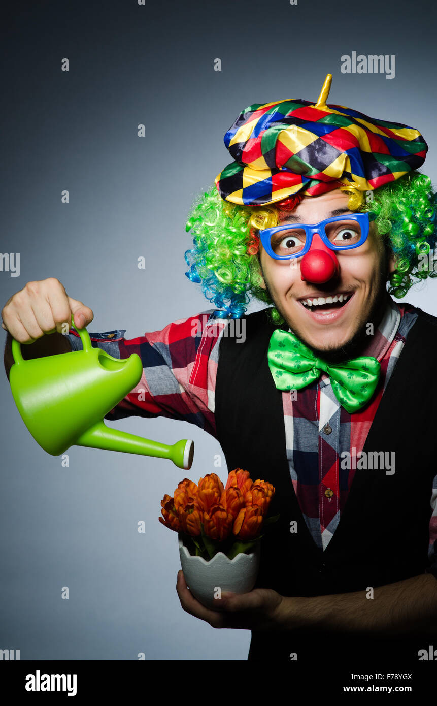 Funny clown with watering can Stock Photo - Alamy