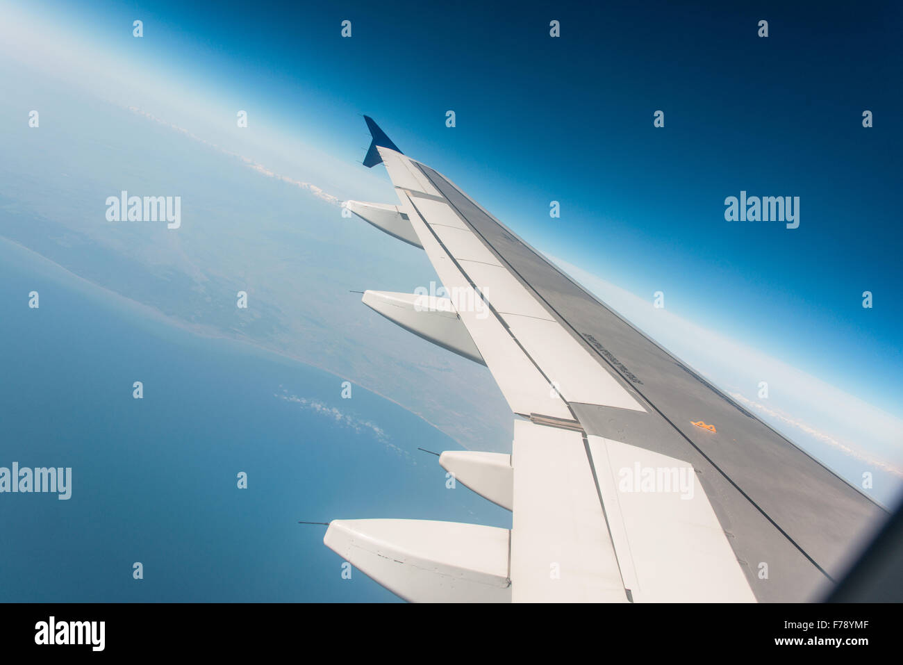 Airplane wing out of window Stock Photo - Alamy