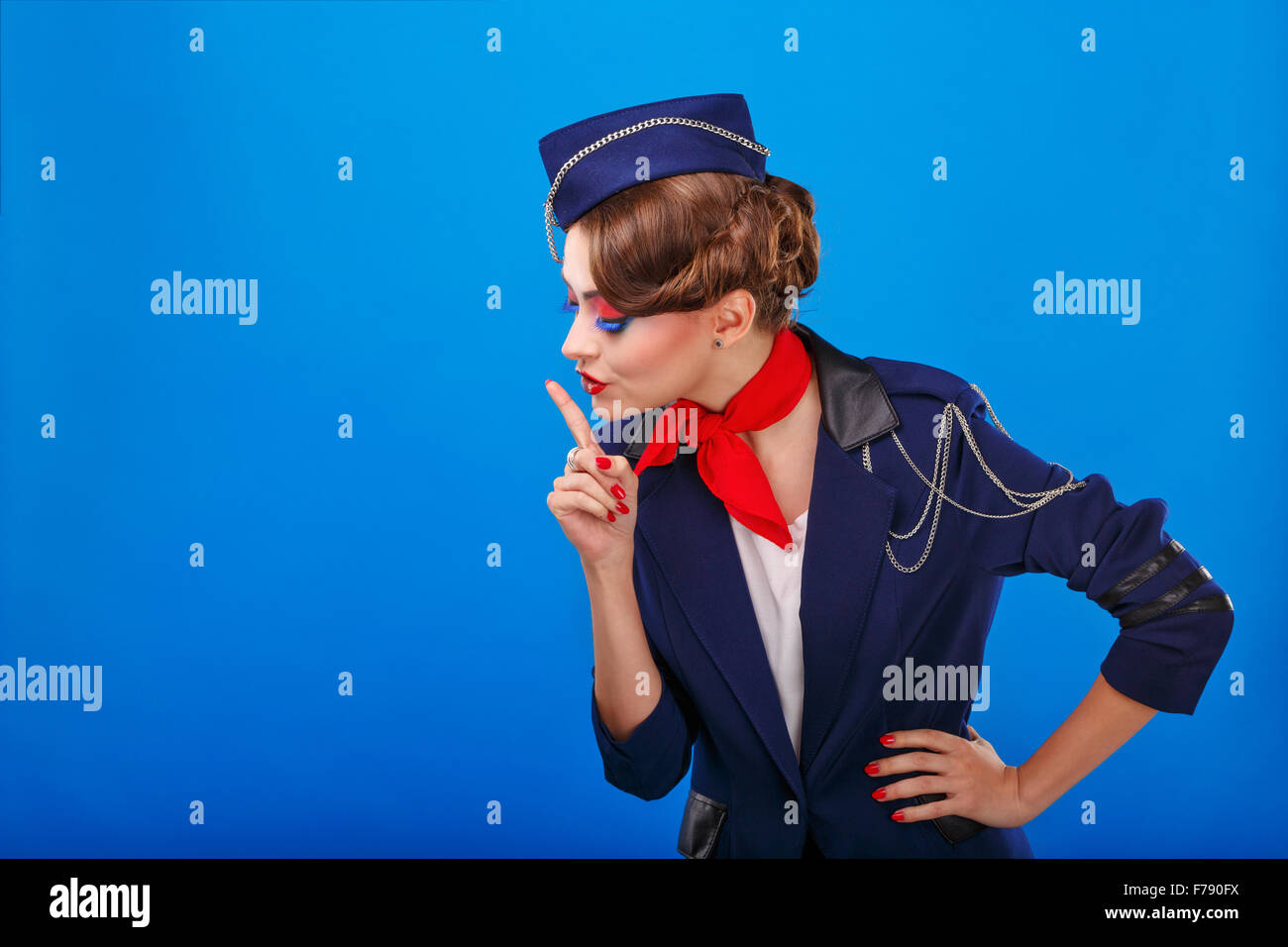 Stewardess with face art asks for silence. Young attractive girl in a ...