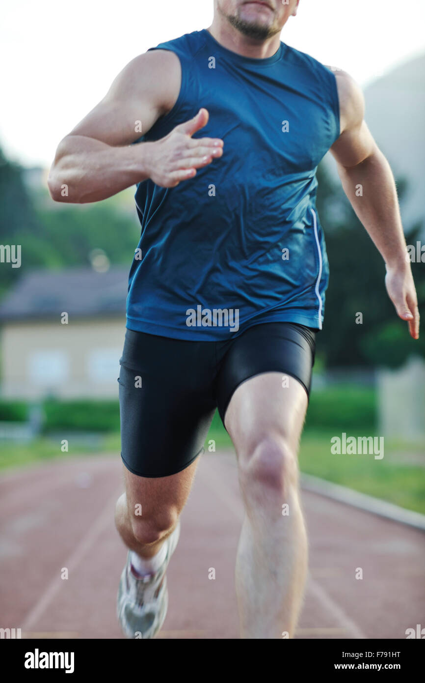 young healthy man run on athletic race sport track and representing ...