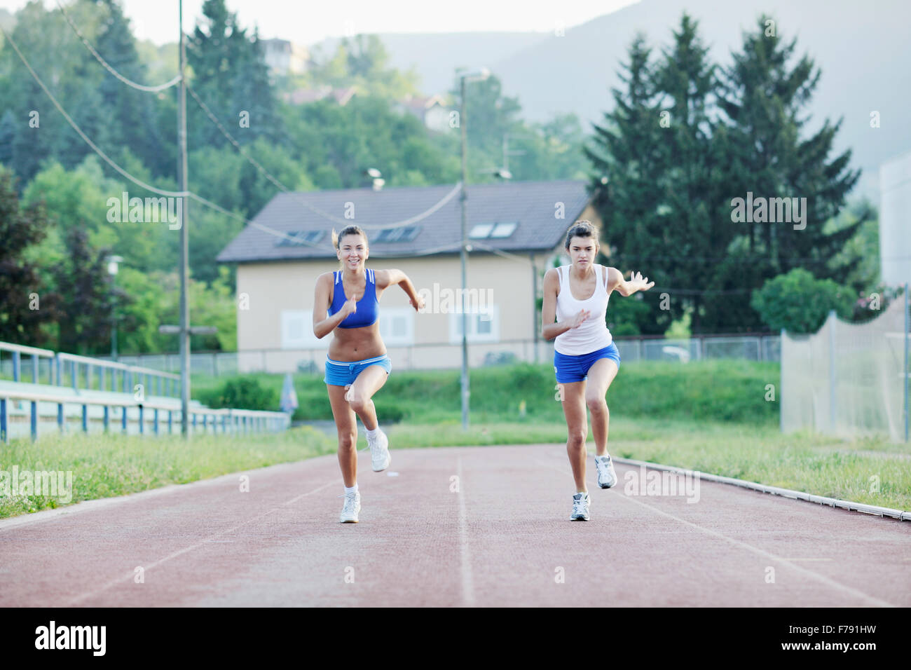 young girl morning run and competition on athletic race track Stock ...