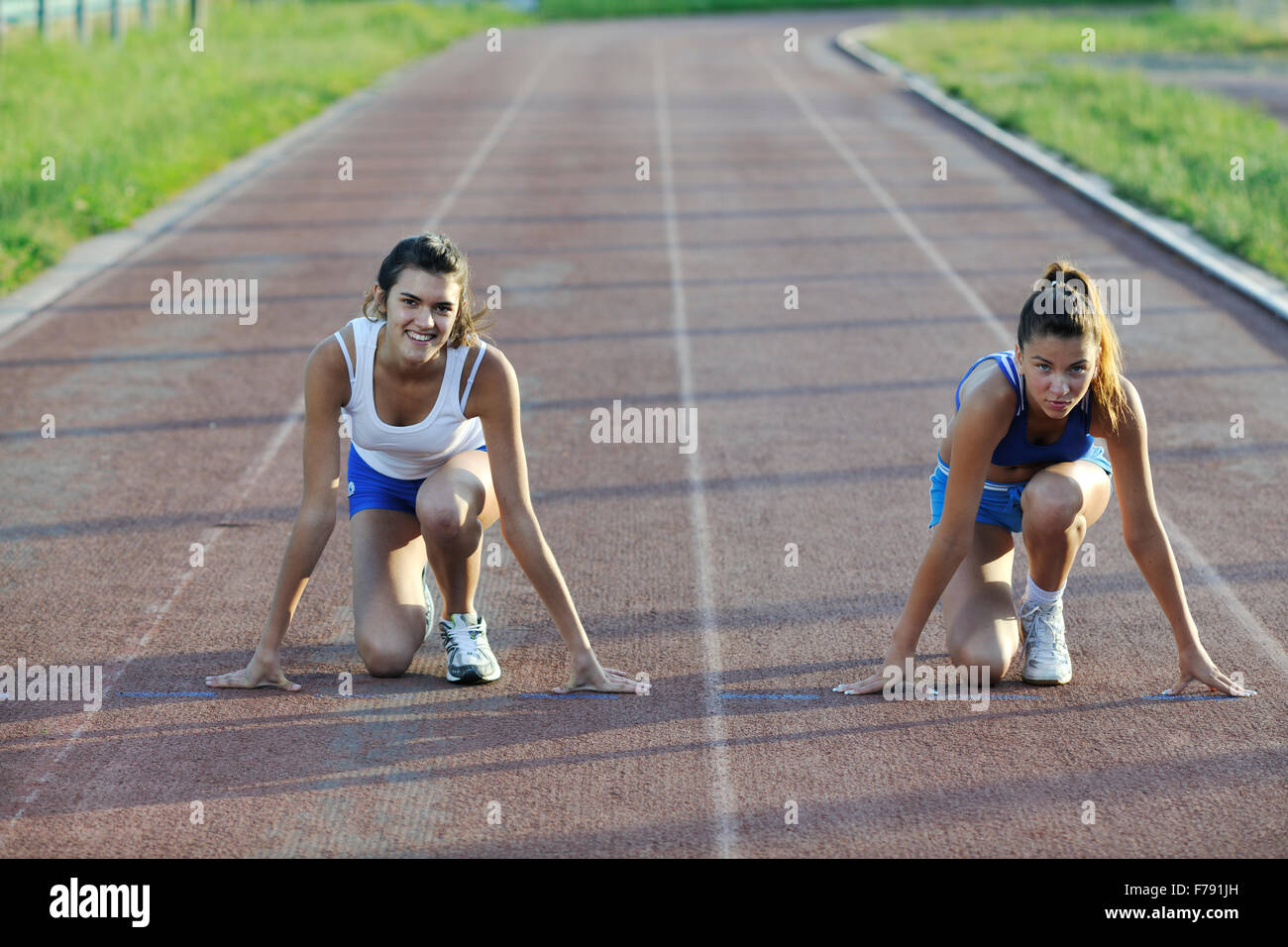 young girl morning run and competition on athletic race track Stock ...