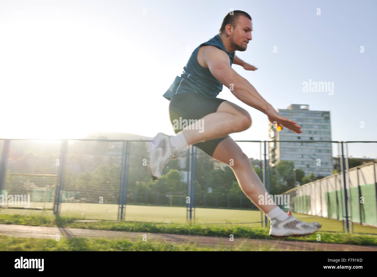 young healthy man run on athletic race sport track and representing ...