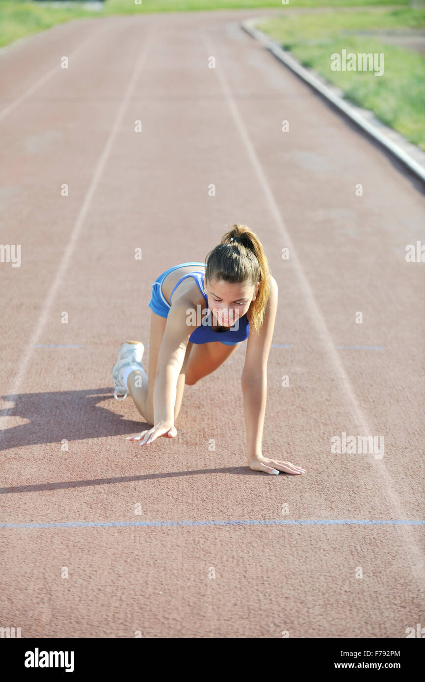 young woman finaly passing finis line at athletics running race track ...
