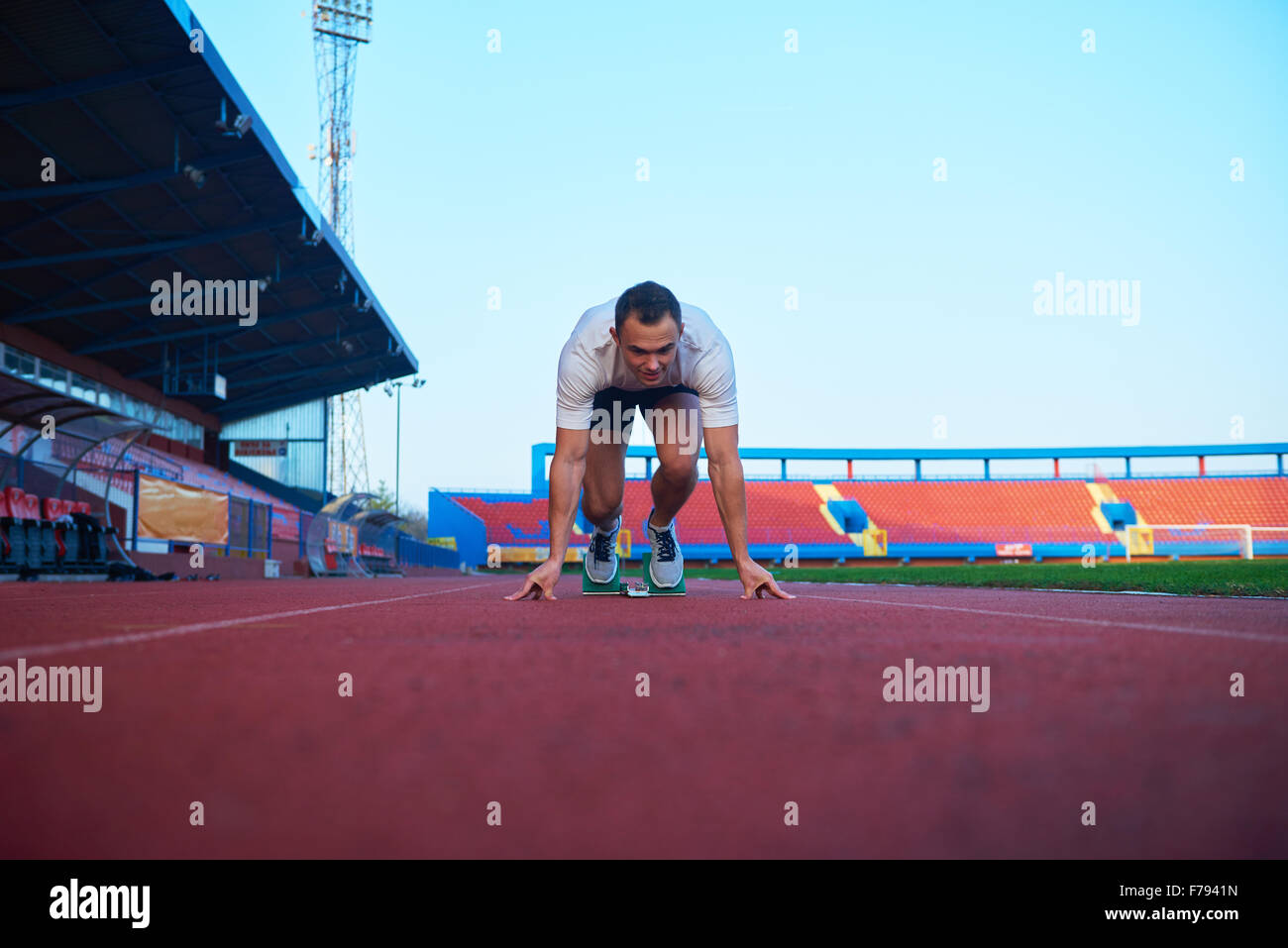 Sprinter leaving starting blocks on the running track. Explosive start ...