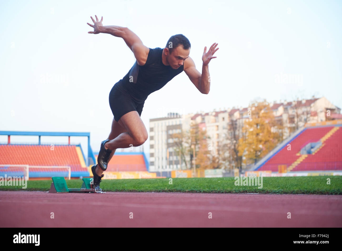 pixelated design of woman sprinter leaving starting blocks on the ...