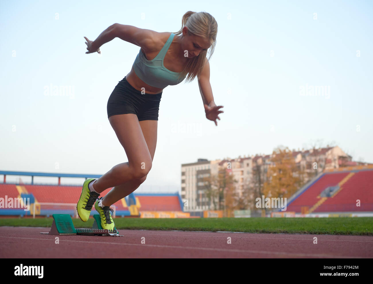pixelated design of woman sprinter leaving starting blocks on the ...
