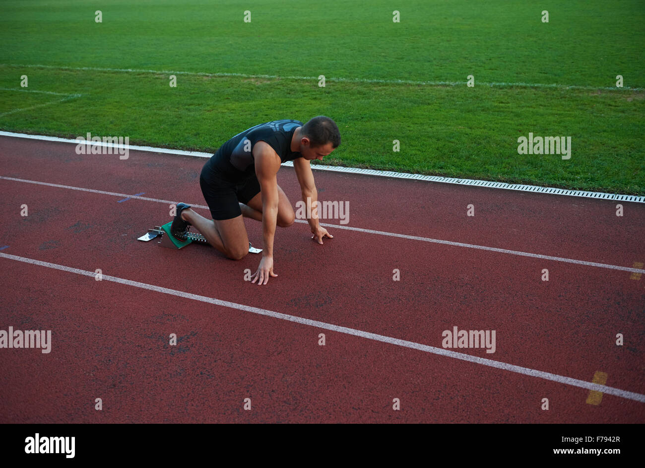Sprinter leaving starting blocks on the running track. Explosive start ...