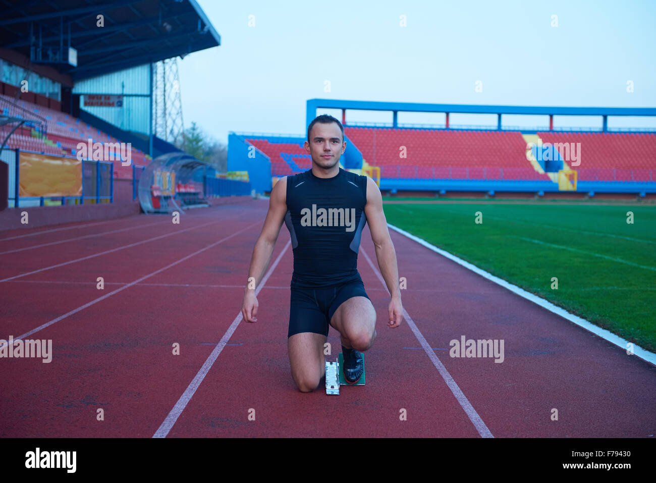 Sprinter leaving starting blocks on the running track. Explosive start ...