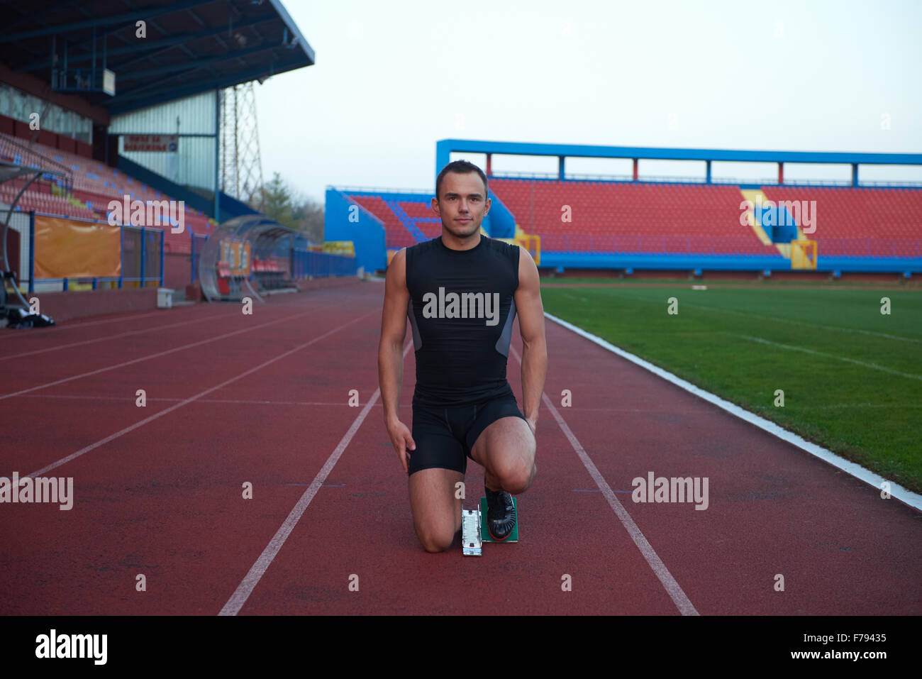 Sprinter leaving starting blocks on the running track. Explosive start ...
