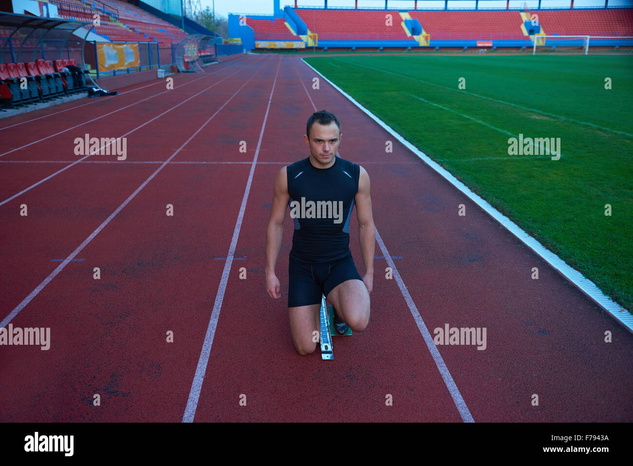 Sprinter leaving starting blocks on the running track. Explosive start ...