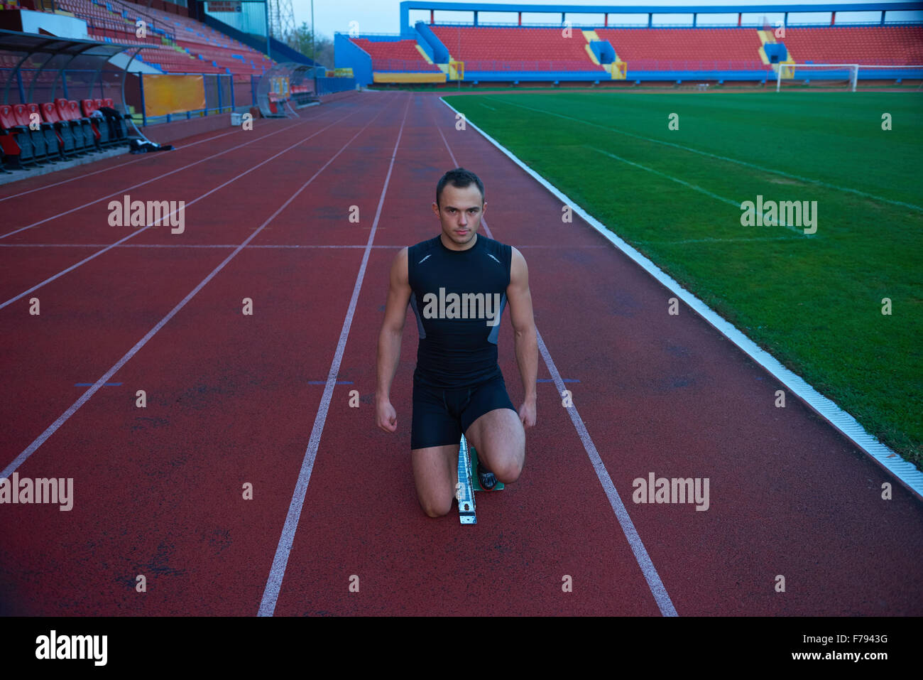 Sprinter leaving starting blocks on the running track. Explosive start ...