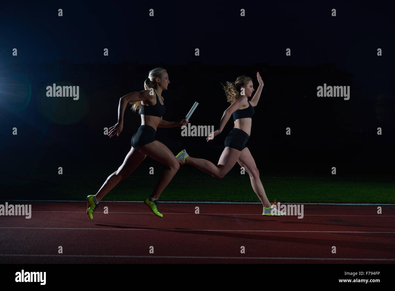 woman athletic runners passing baton in relay race Stock Photo - Alamy