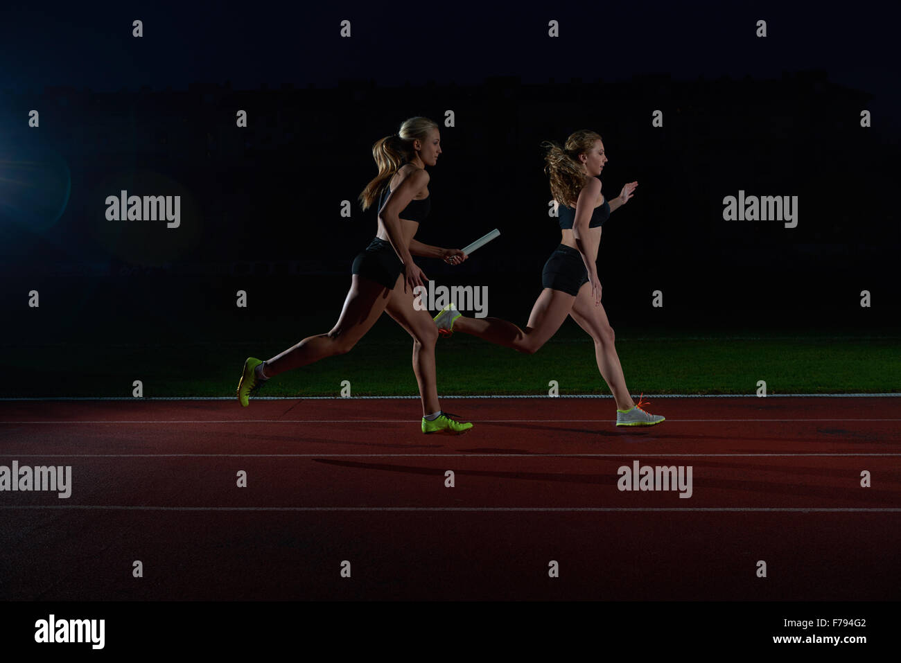 woman athletic runners passing baton in relay race Stock Photo - Alamy